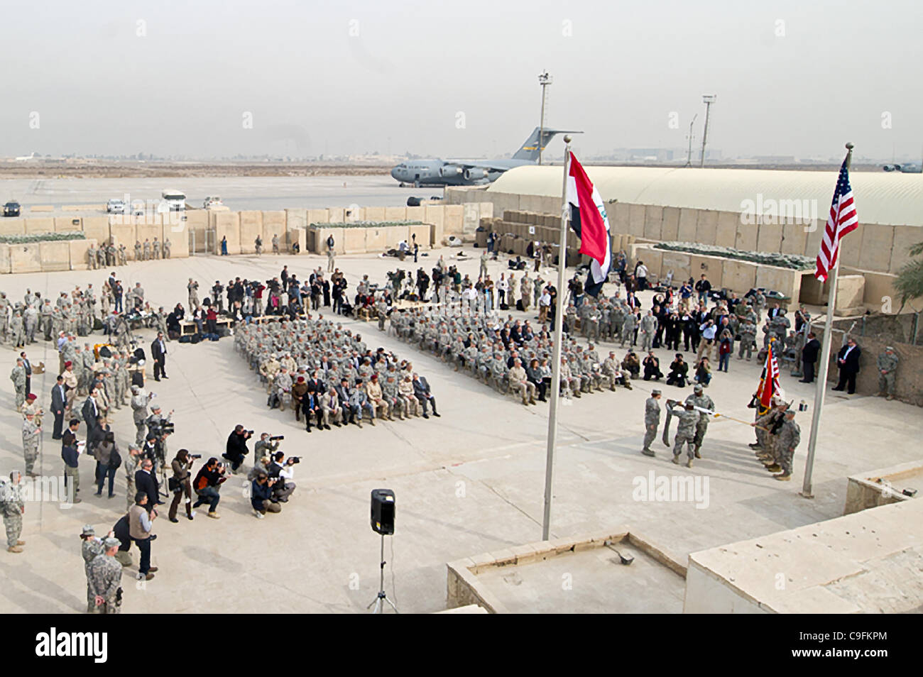 The US flag and military colors are secured during the end of mission ...