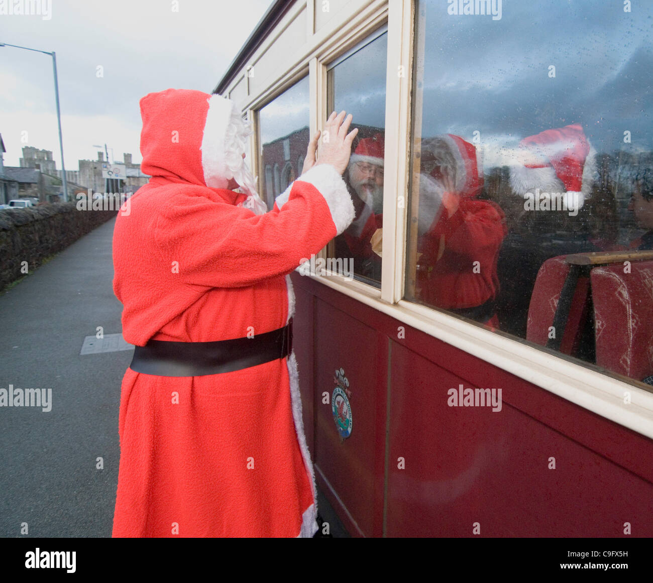 Santa and his elves entertain and give out presents to children aboard ...