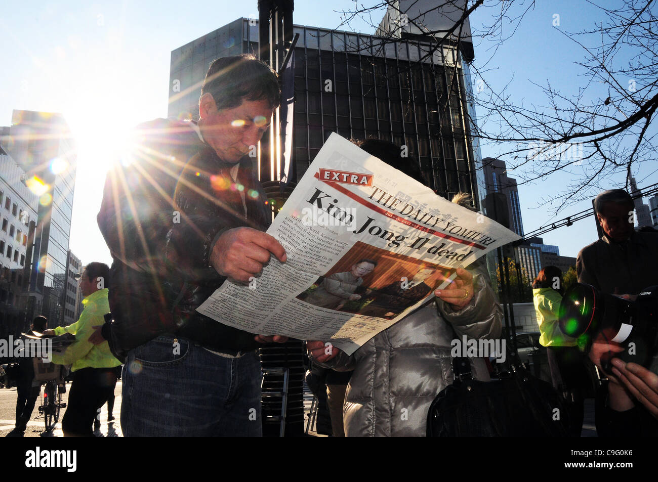 Dec. 19, 2011 - Tokyo, Japan - Pedestrians read an extra edition ...