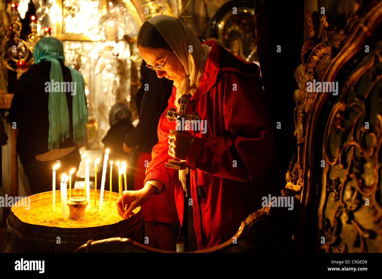 A Christian devotee lights candles inside the Church of the Holy ...