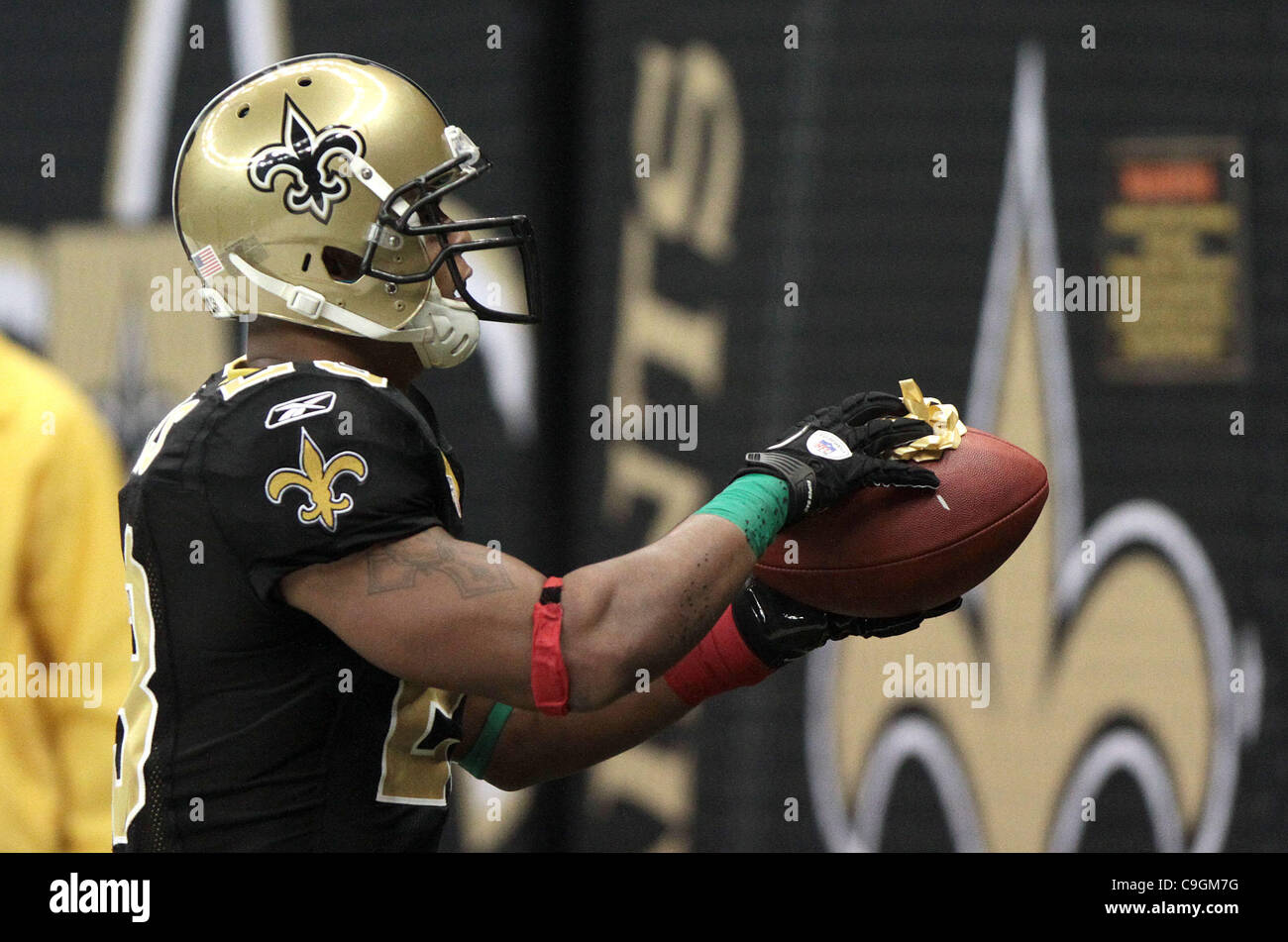 New Orleans Saint Pierre Thomas hands a touchdown ball with a bow on ...