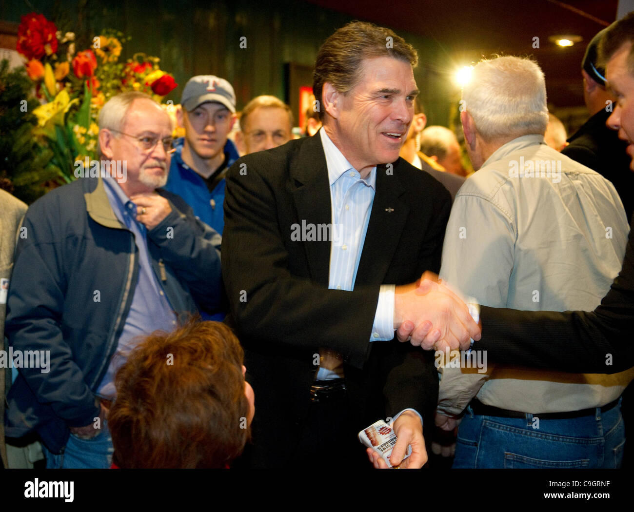 Republican presidential candidate Rick Perry greets supporters during a ...