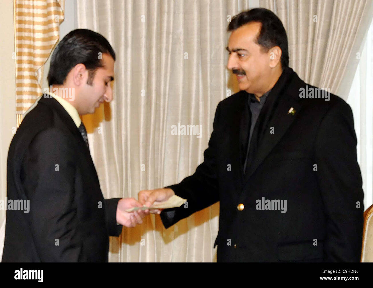 Prime Minister, Syed Yousuf Raza Gilani presents a cheque of one ...