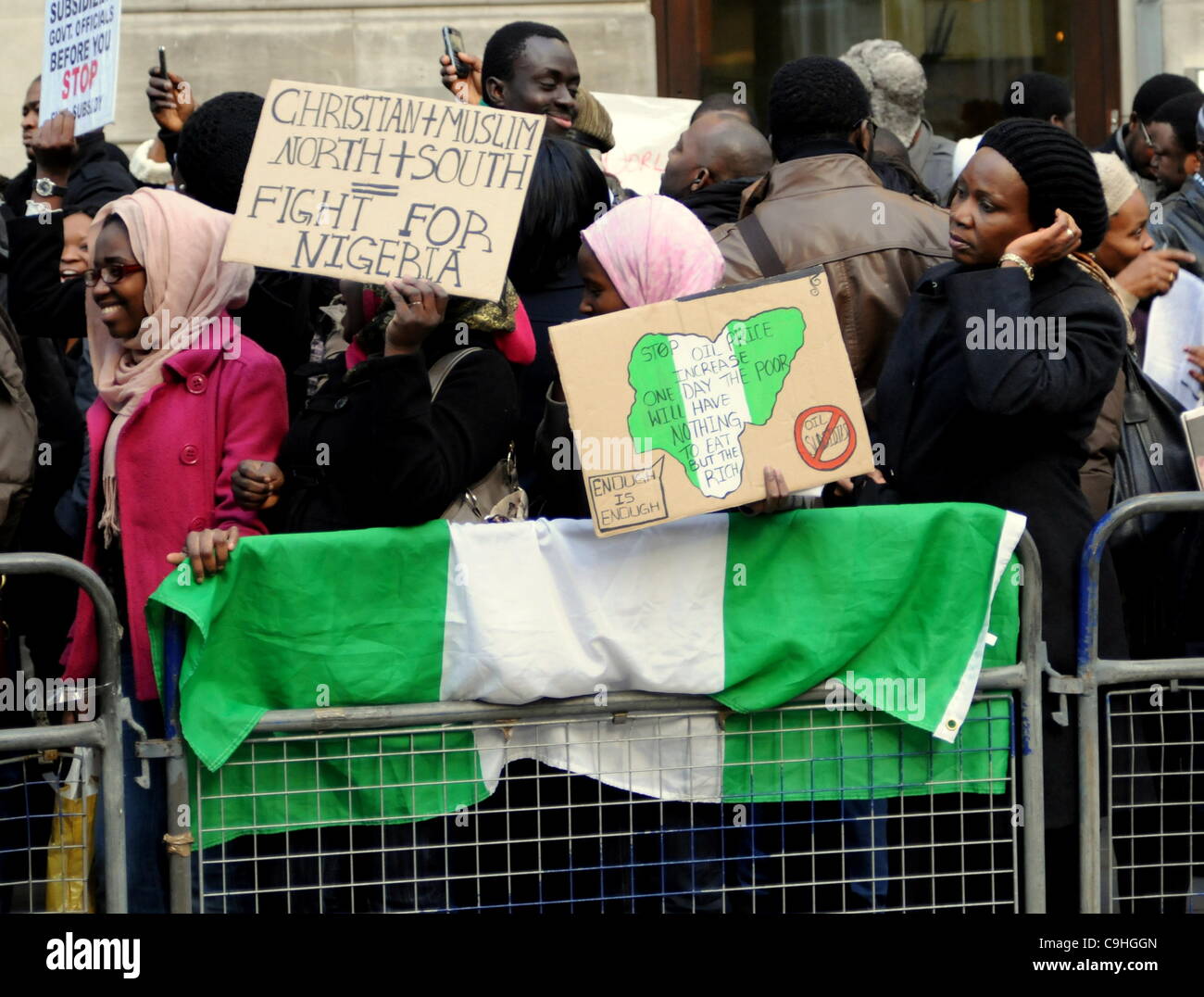Nigerian protesters waving flags and holding banners at the ...