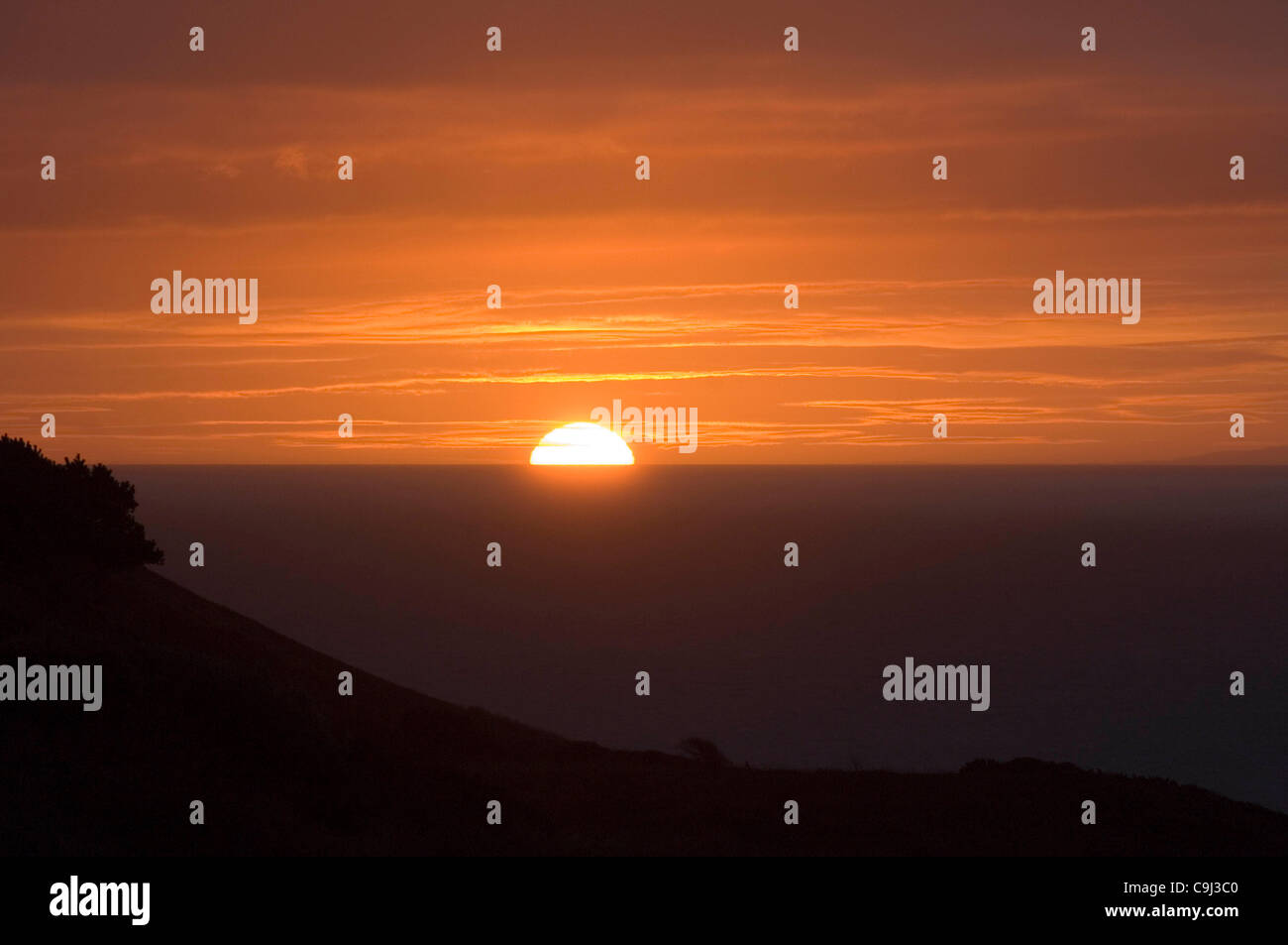 The winter sun rises above the horizon over the North Devon Coastline ...