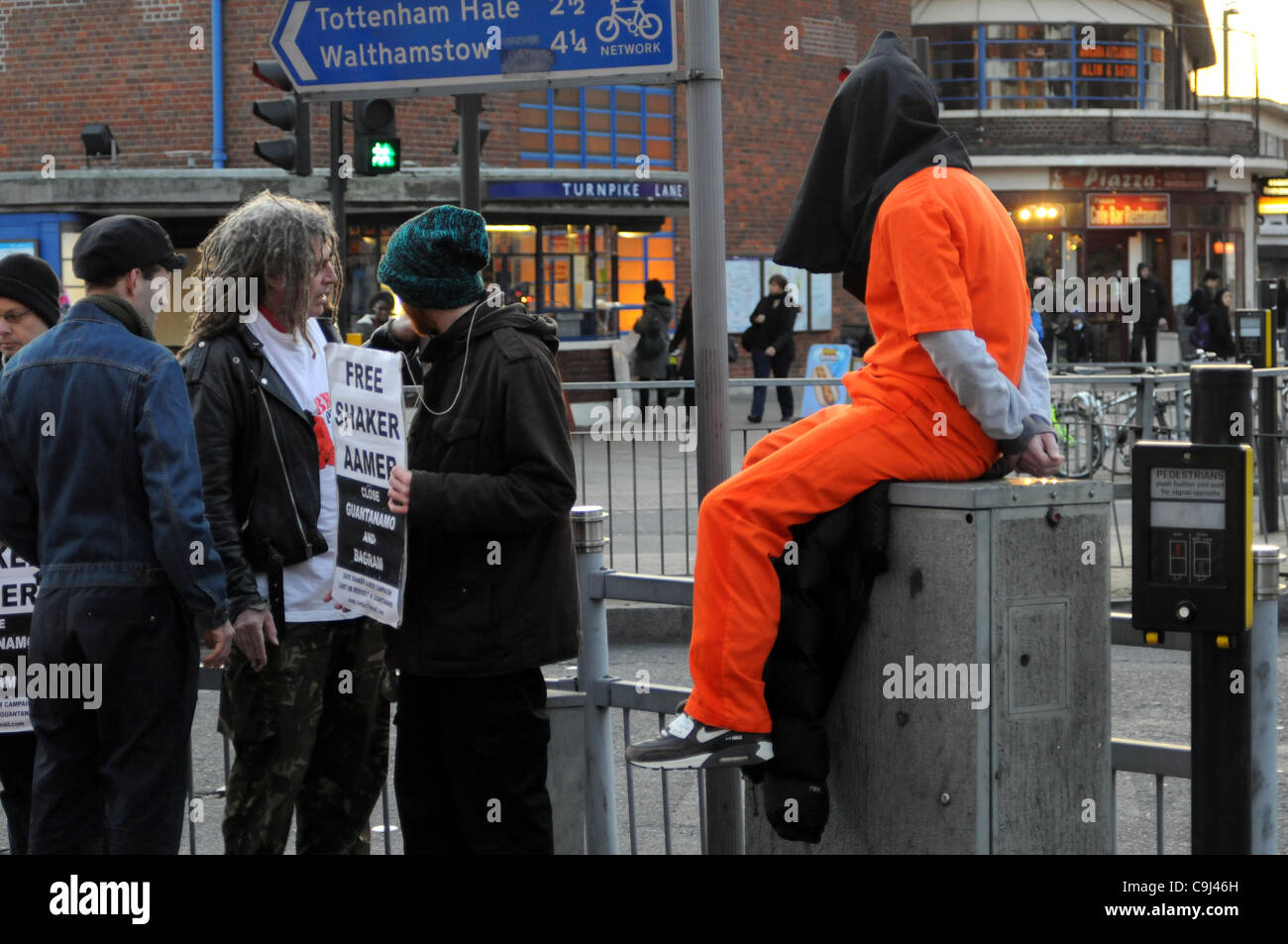 London, UK. 11th Jan, 2012. A protester wearing an orange prison jump ...