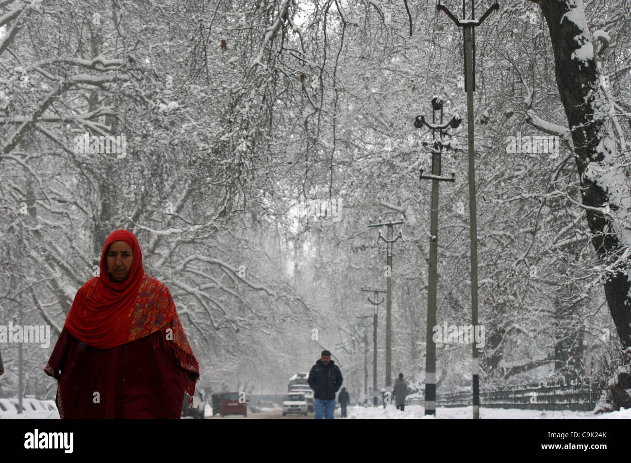 A kashmiri muslim women walk during snow fall in srinagar, the summer ...