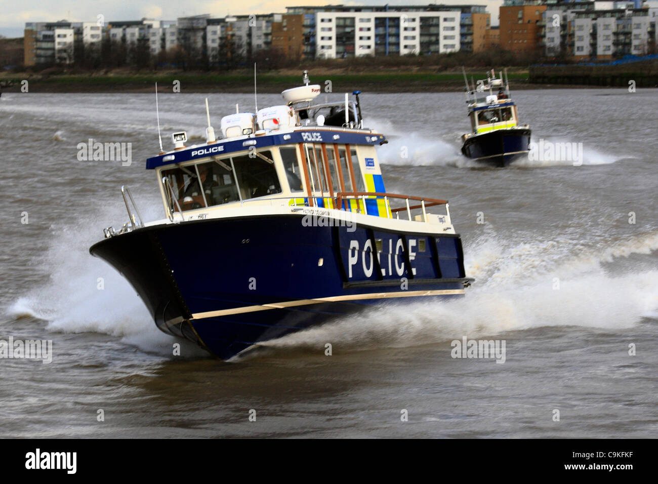 London, UK. 19th Jan, 2012. Police launches speed down the River Thames ...