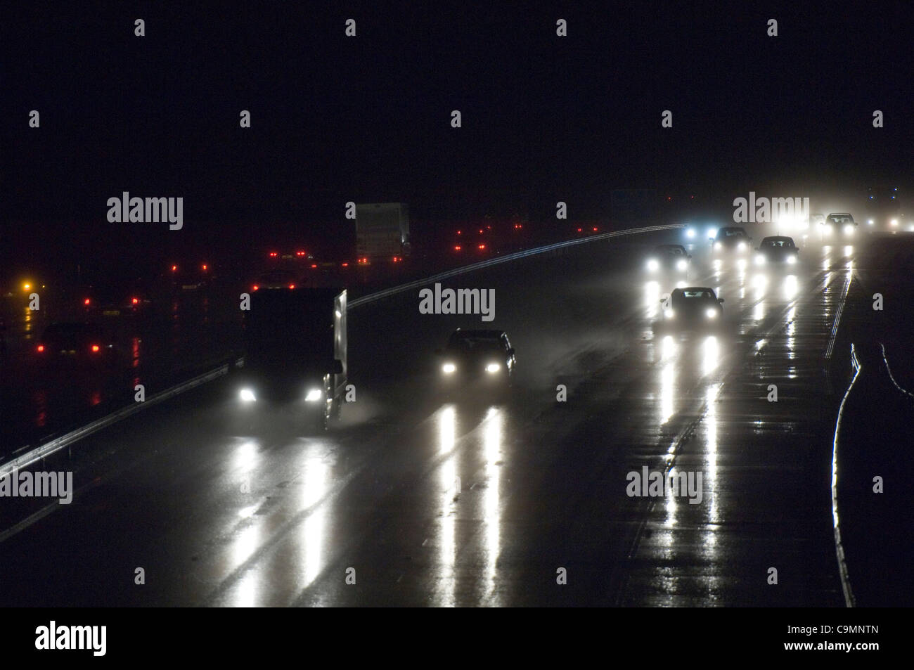 Rush hour motorists driving through sleet on the M4 near Cardiff, South ...