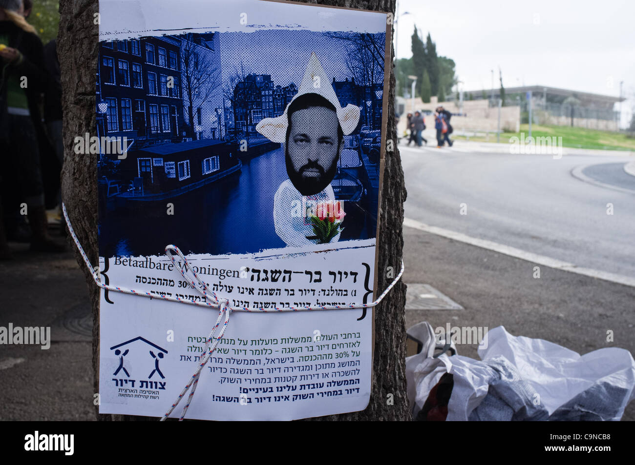 A poster on a tree opposite the Knesset building portrays Housing ...