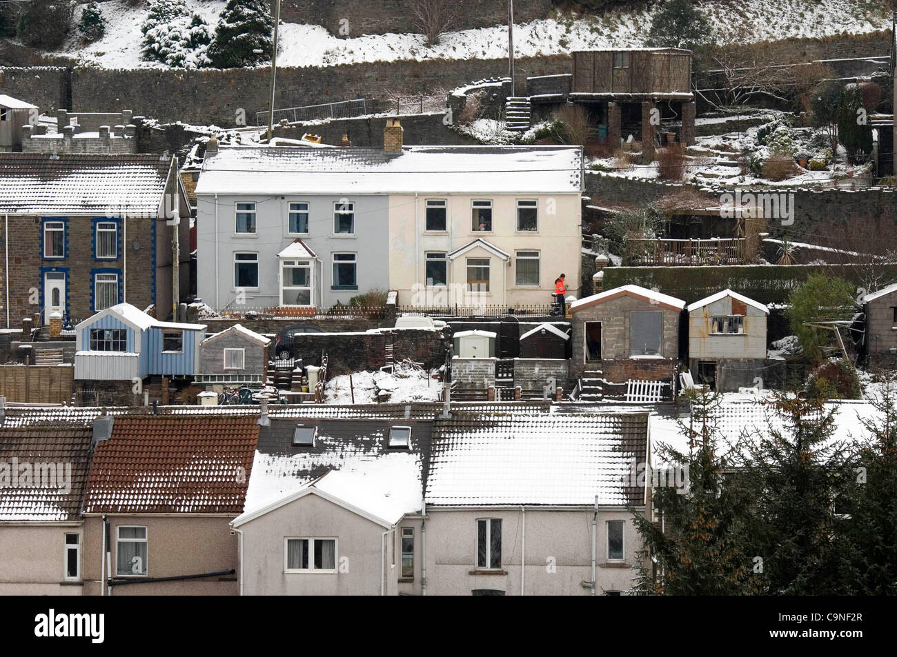 A postman delivering letters to the snow covered homes in Abergwynfi in ...