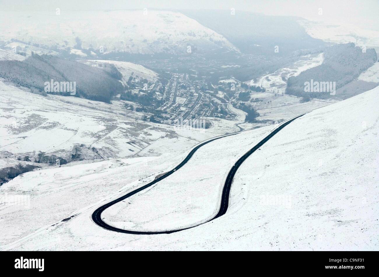 A car making it's way slowly up to the snow covered remote mountain ...