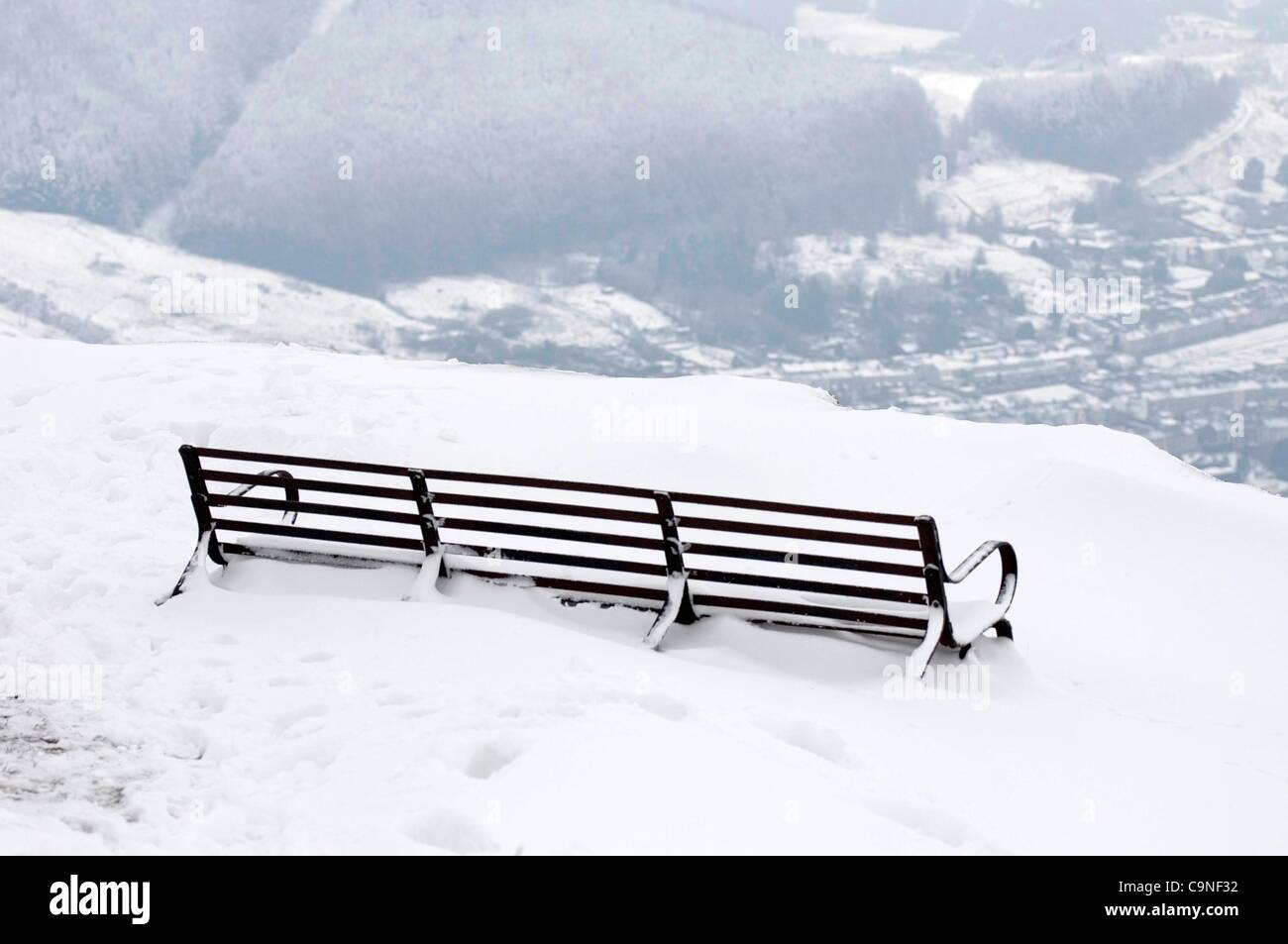 A seat covered in snow at the top of the remote mountain road that ...