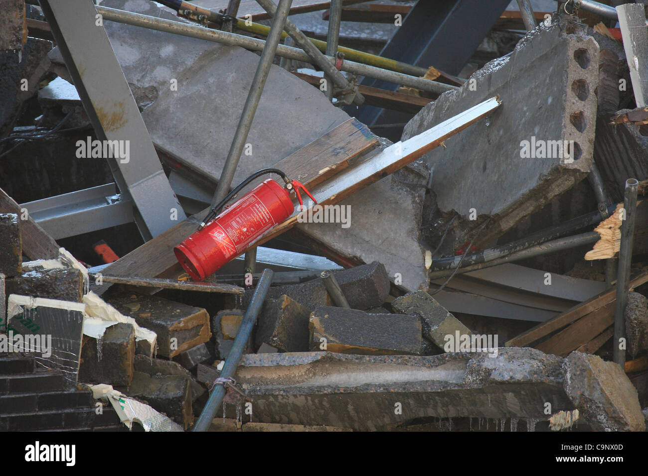 TA fire extinguisher sits forlornly amongst the debris of a collapsed ...