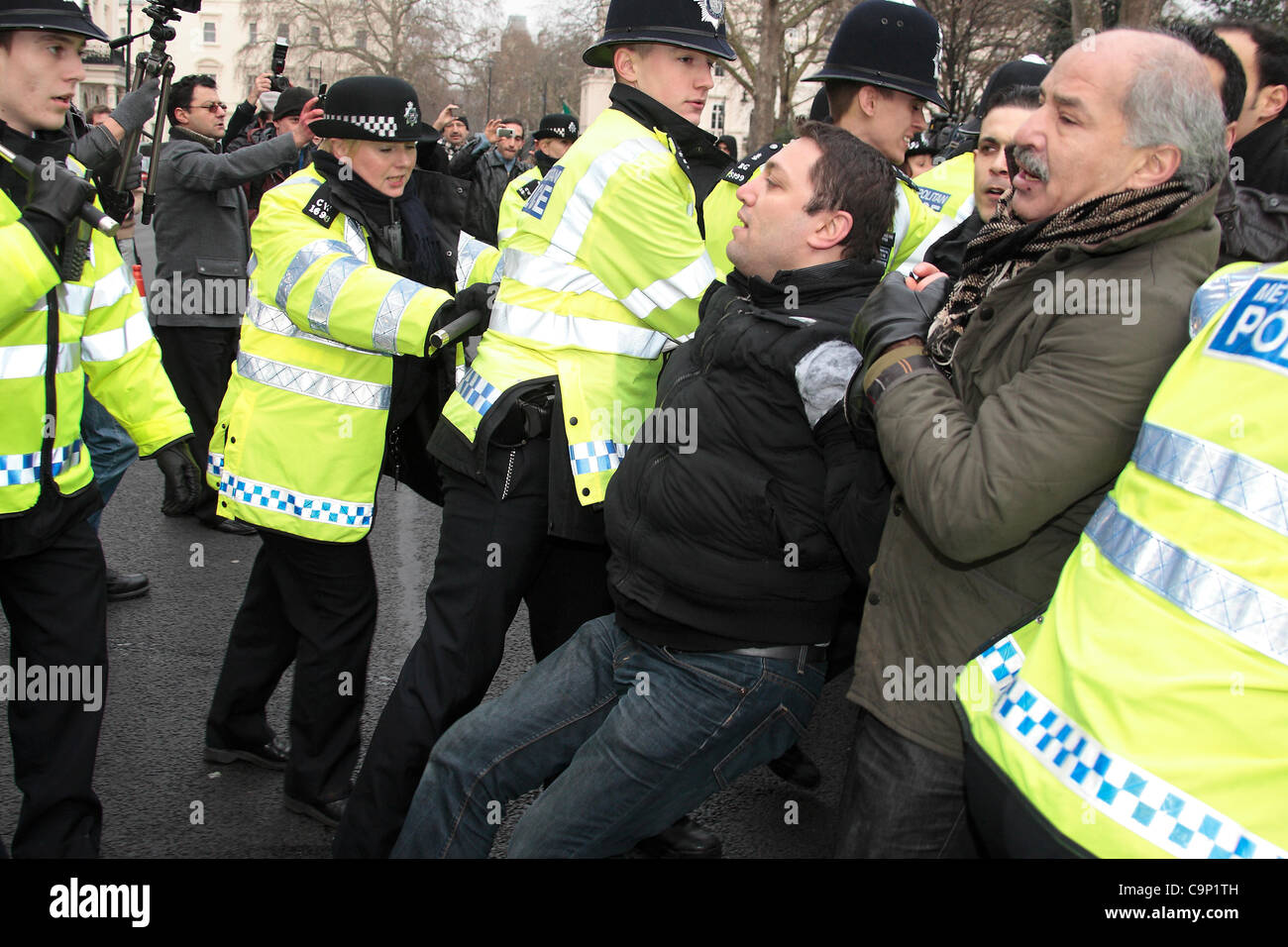 Syrian protesters clash with police outside the Syrian Embassy in ...