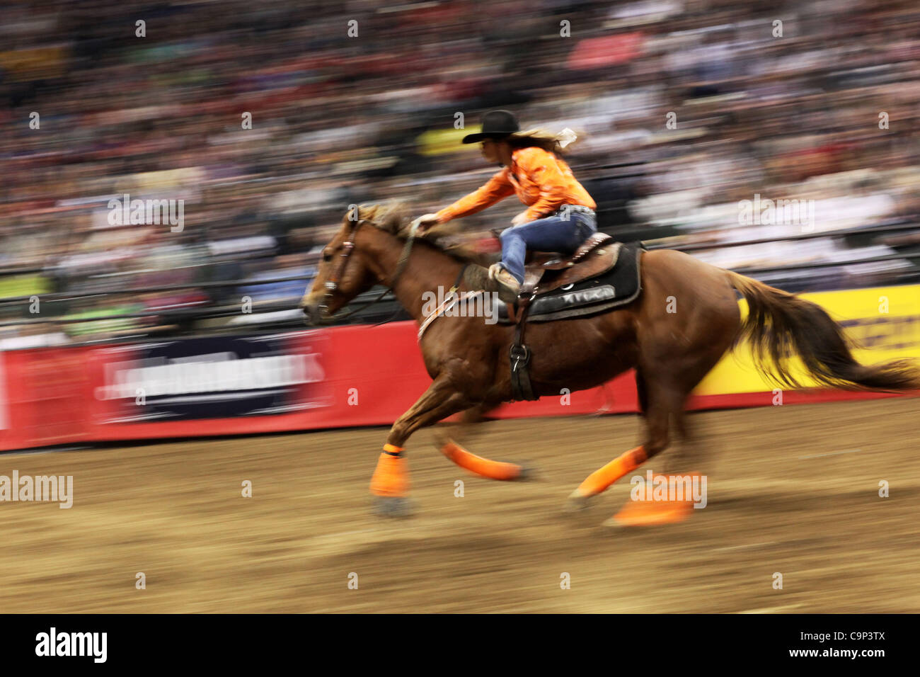 A cowgirl urges her horse forward during the barrel racing portion of ...