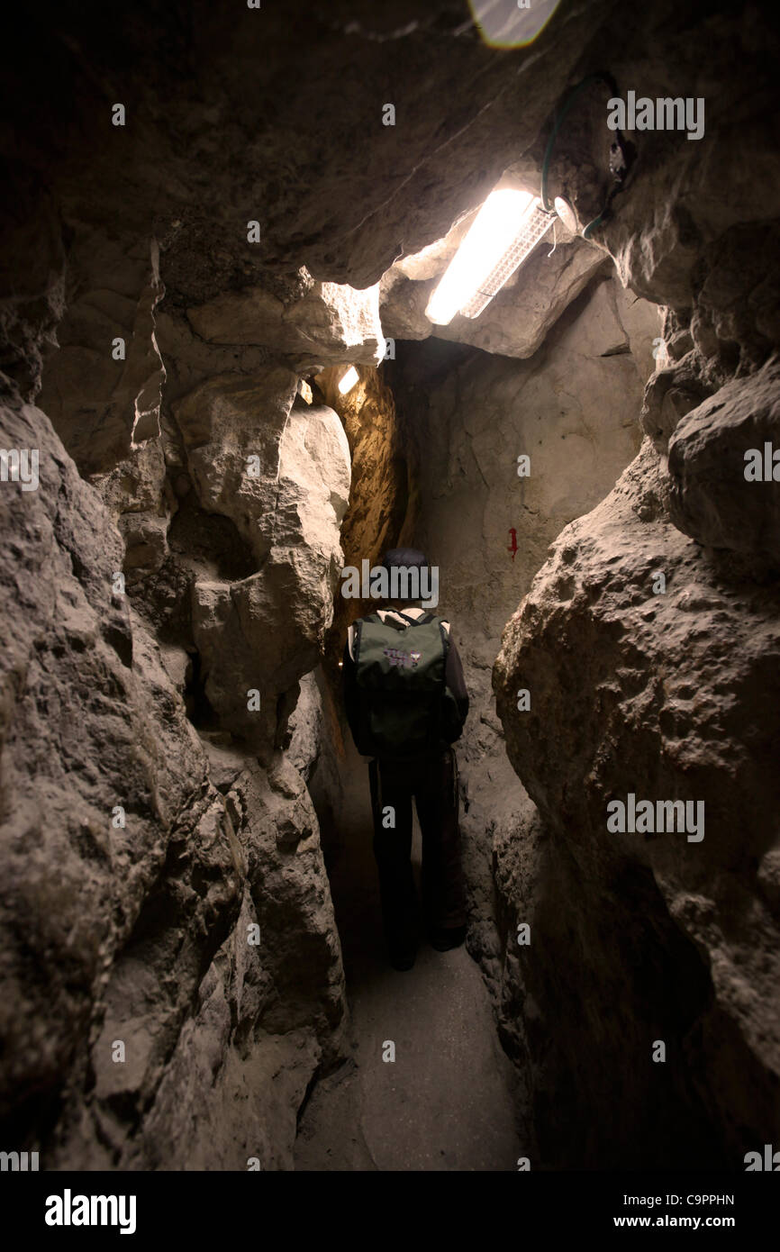 A Jewish schoolboy walks through at the underground narrow Siloam or ...