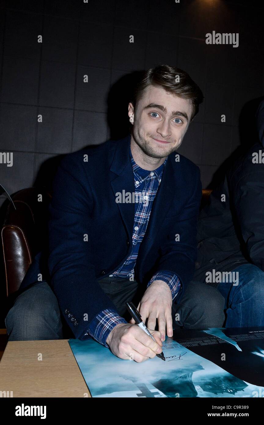London, 11.2.12. Daniel Radcliffe signs posters before introducing a ...