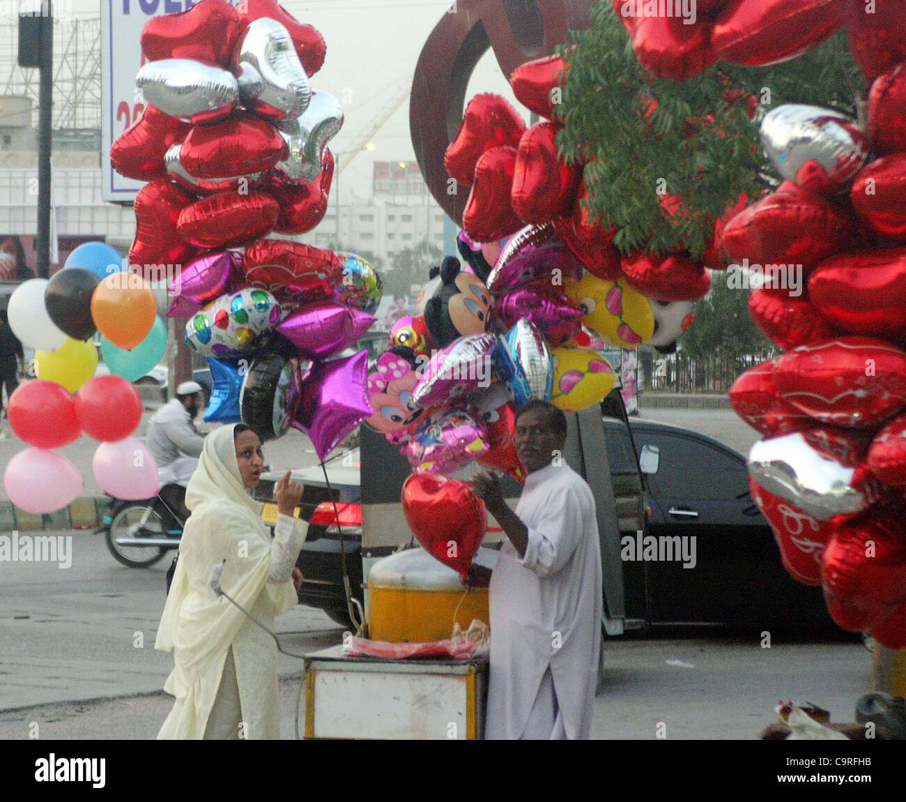 KARACHI, PAKISTAN, FEB 13: A street vendor sells heart-shaped balloons ...