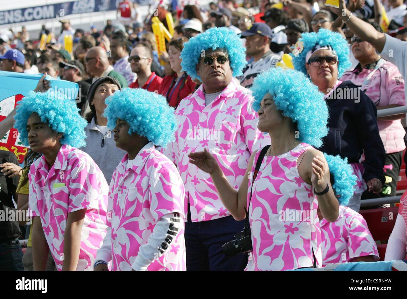 Fijian rugby fans wearing bright blue wigs at a public appearance for ...