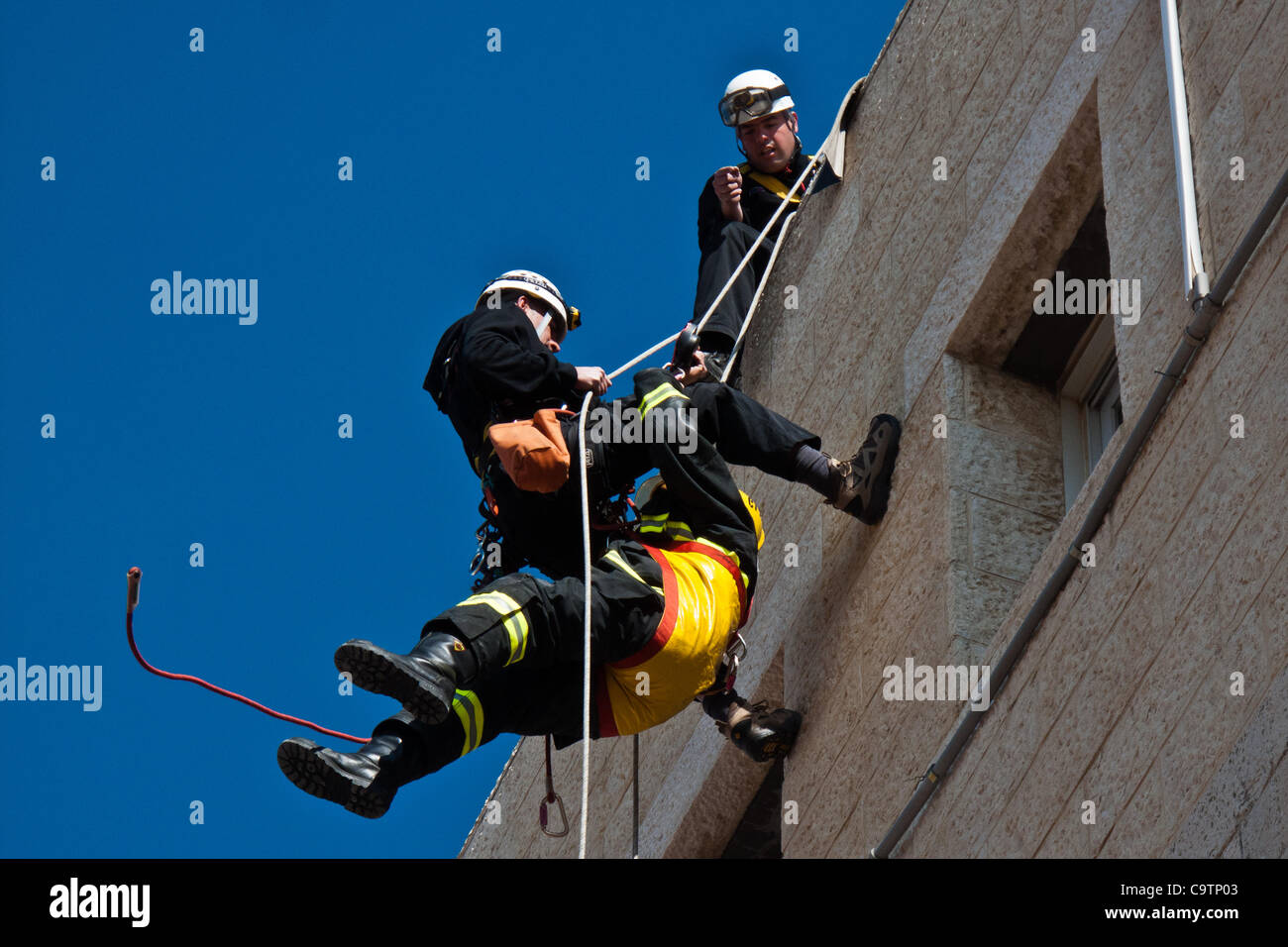 Firefighters rappel from school rooftop in rescue operations following ...