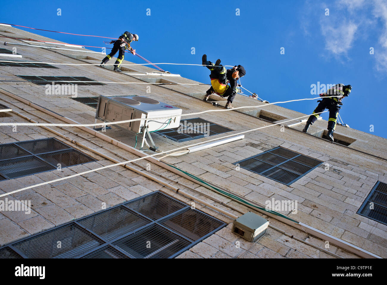 Firefighters rappel from school rooftop in rescue operations following ...