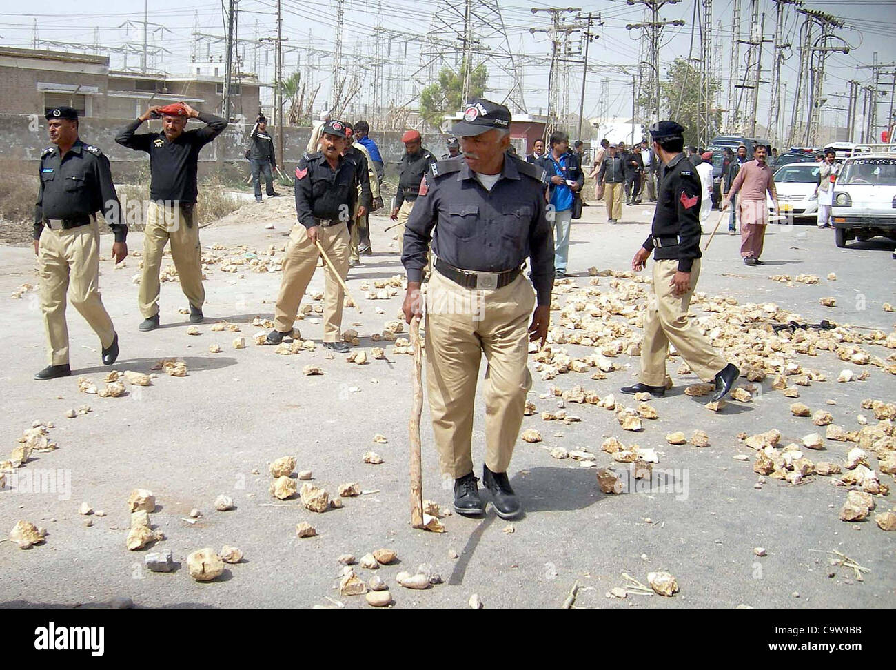 Policemen stand guard to avoid any untoward incident as angry ...
