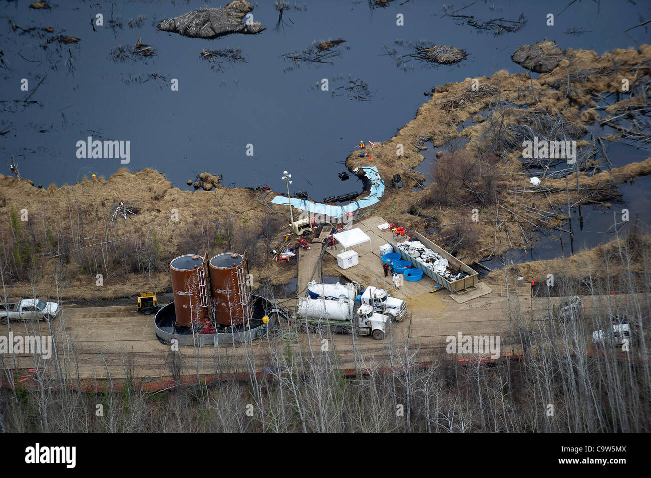 Crews work to clean up oil at a beaver dam from a pipeline spill, owned ...