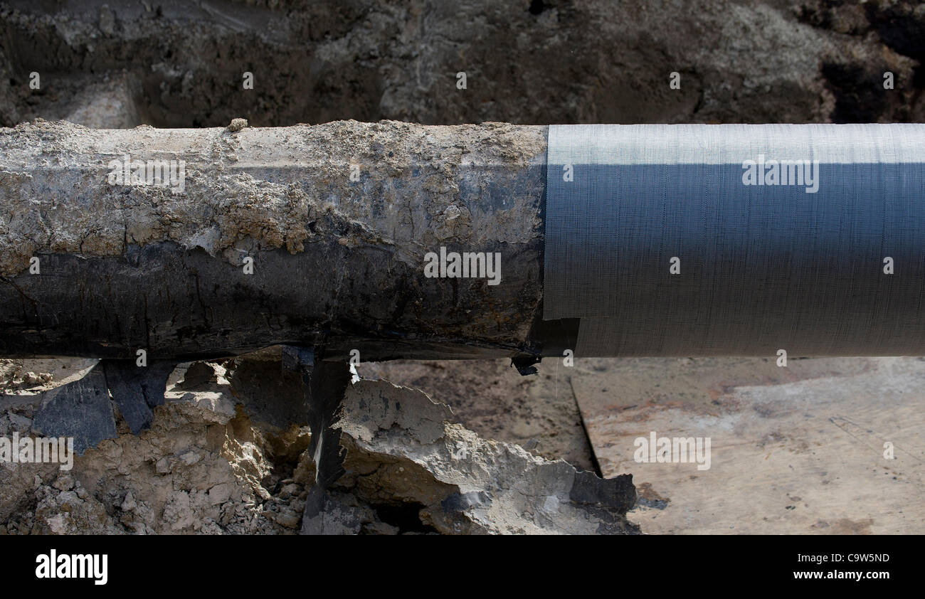 Crews work to clean up oil at a beaver dam from a pipeline spill, owned ...
