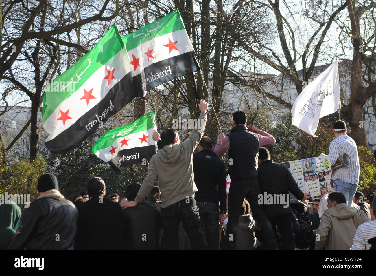 London, UK. 25/02/12. Syrian flags are waved as, around 200 Syrian ...