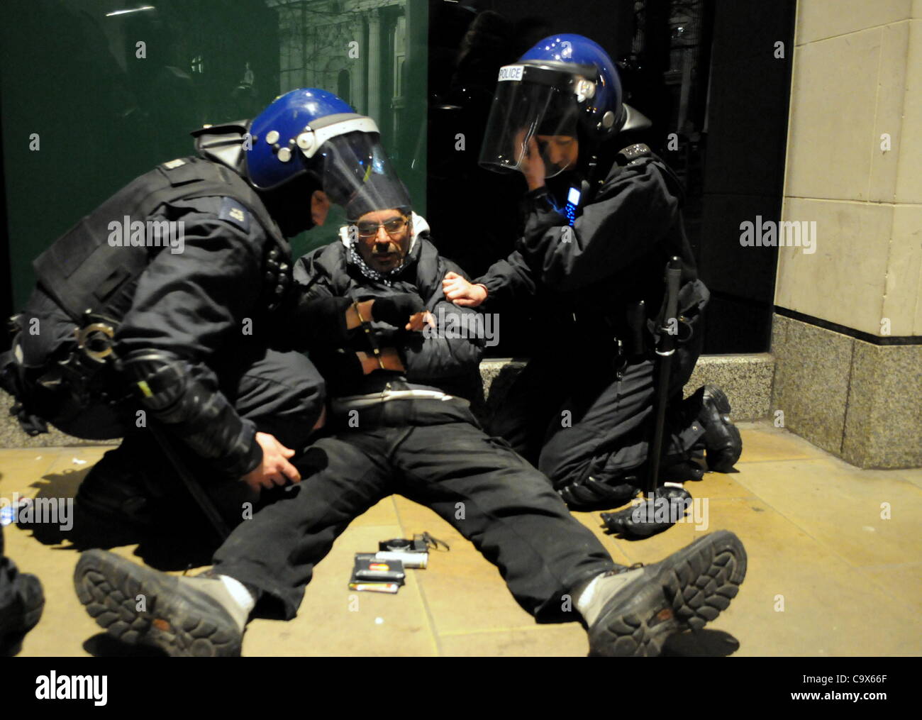 London, UK. 28/02/12. Riot police arrest a protester as bailiffs evict ...