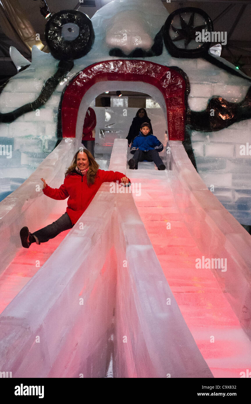 A woman slides down the ice on the famous ‘Monster’ slide carved of ice ...