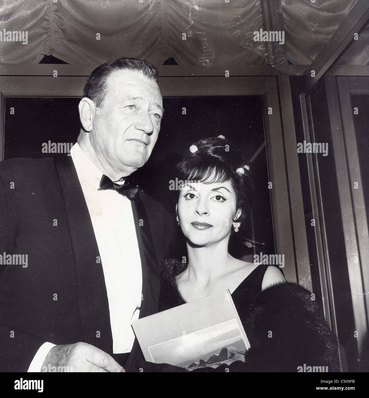 JOHN WAYNE with Pilar Wayne at the premiere of West.Supplied by Photos ...