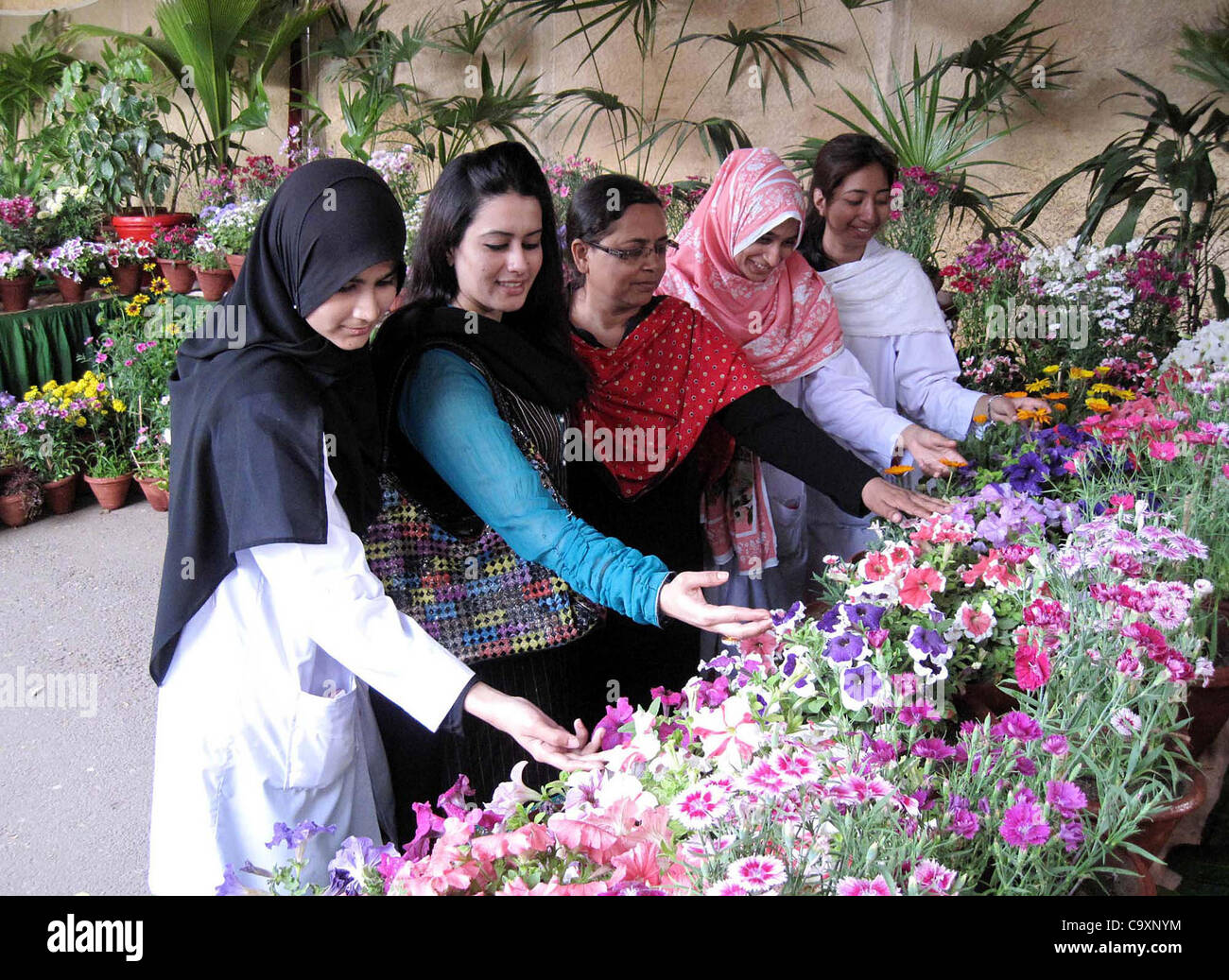 Women look flowers during Flowers Show held at Karachi Zoo on Friday ...