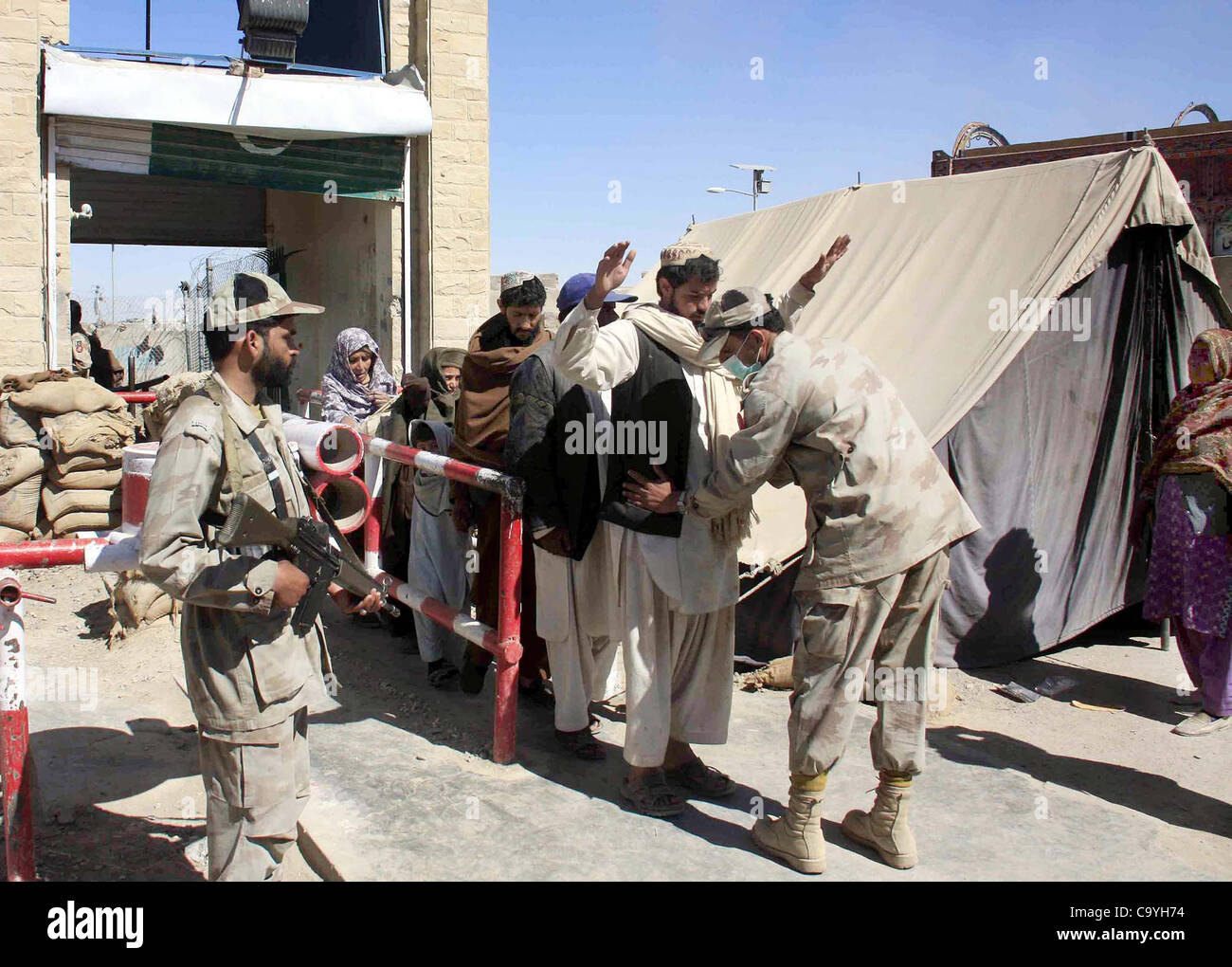 A security official takes body search of people who were entering in ...