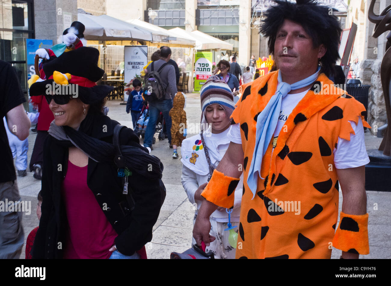 Adults wearing costumes on Purim, celebrated as a happy, carnival-like ...