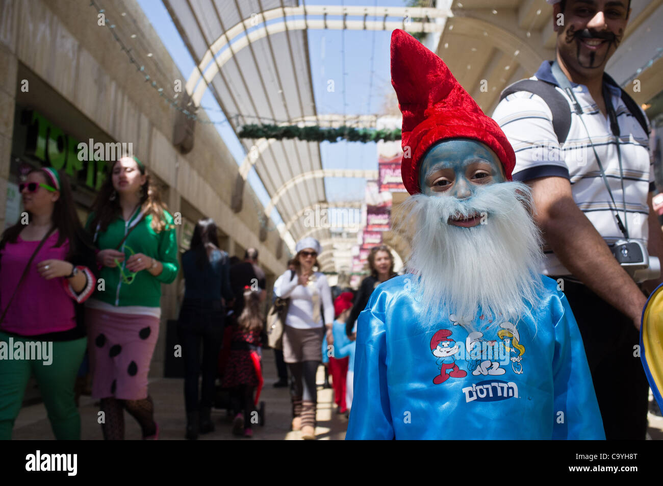 A boy wears a Smurf costume on Purim, celebrated as a happy, carnival ...