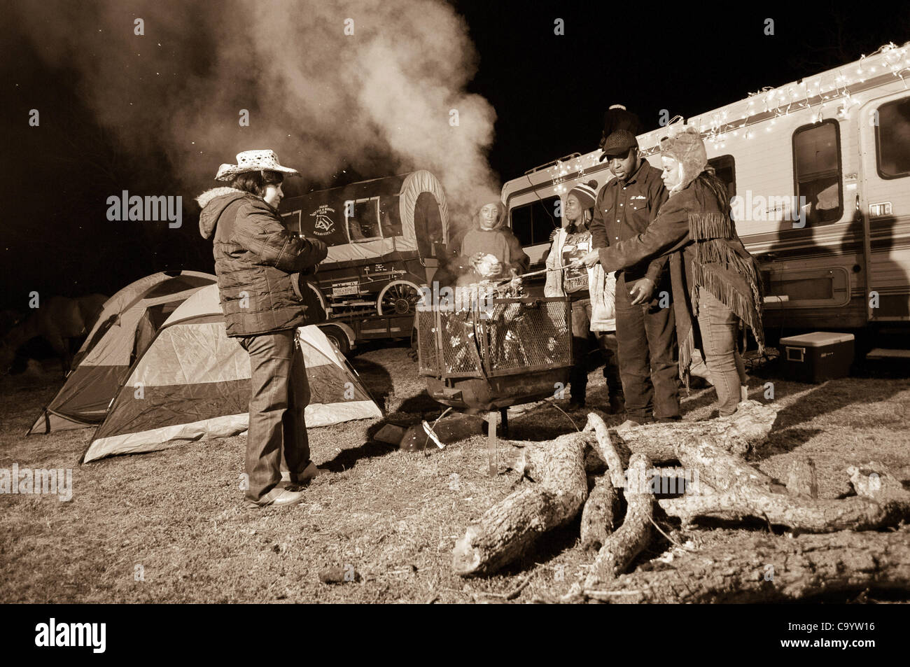Campers get warm by the fire after a December trail ride near Danciger ...