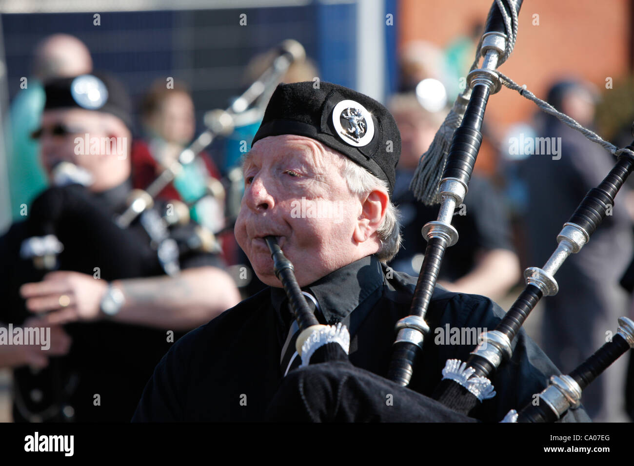 St Patrick's day parade in Birmingham UK. A piper marching through ...