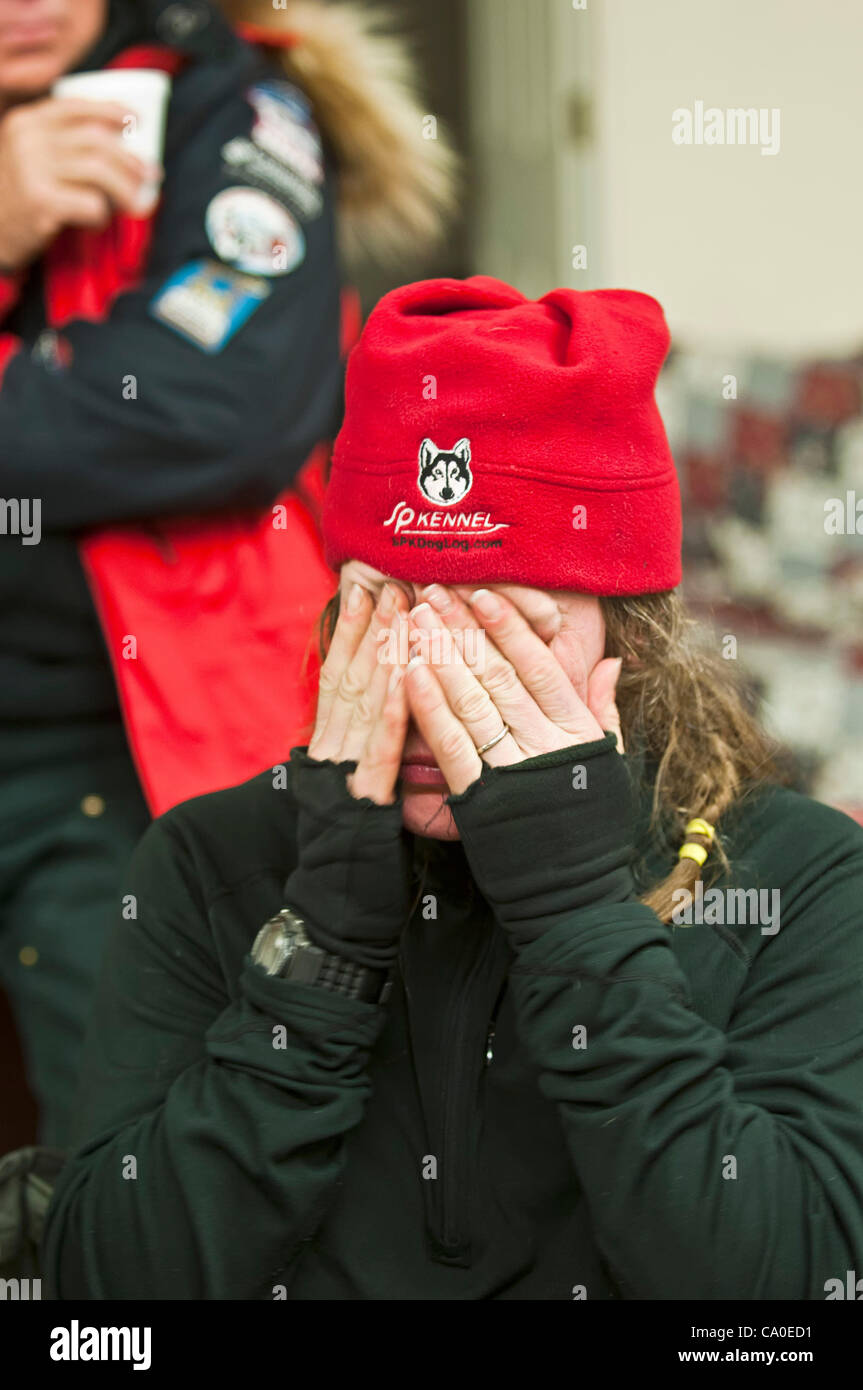 A tired Aliy Zirkle, currently in the lead, rests at Unalakleet ...