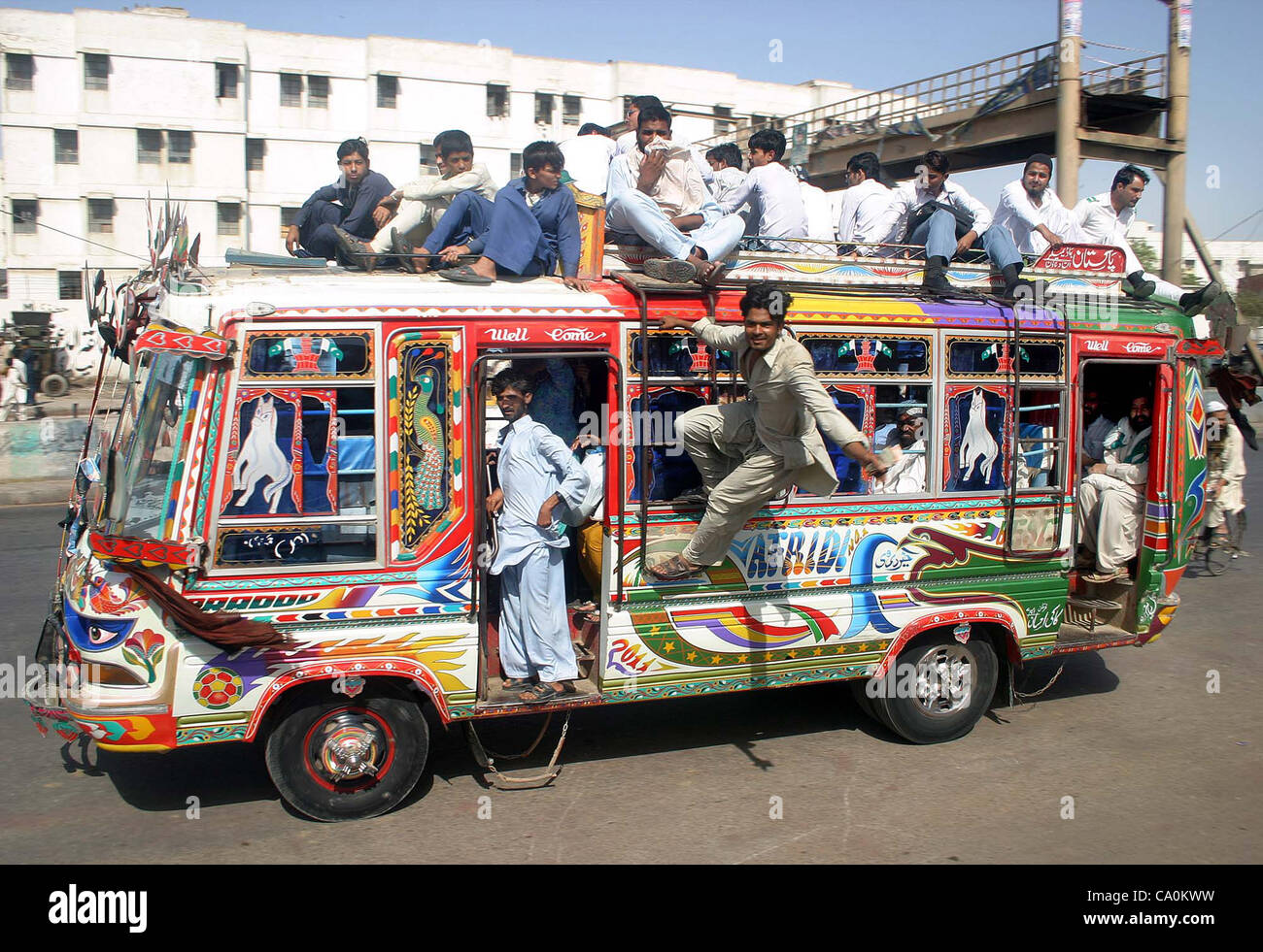 People travel on an overloaded passenger bus as residents of city are ...