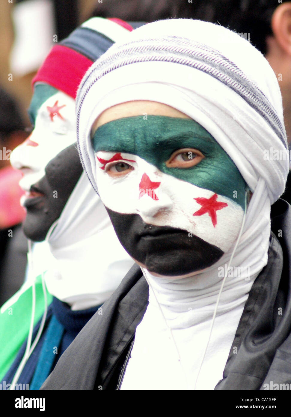 London, UK. 17/03/12. A female protester with the Syrian Flag painted ...