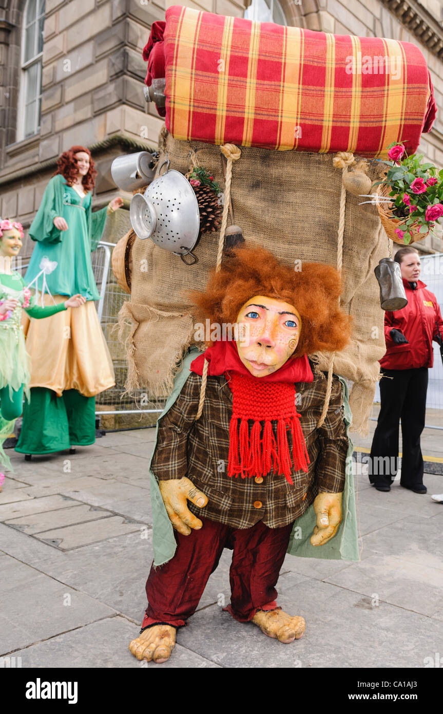 Belfast, UK. 17 Mar, 2012. Person dressed as Irish Leprachaun carrying ...