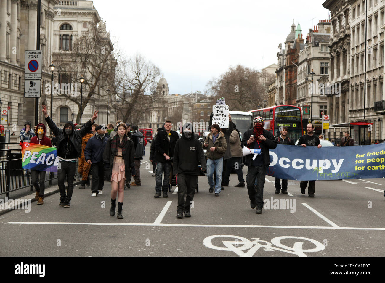 London, UK. 18 Mar, 2012. Members of the Occupy London movement march ...