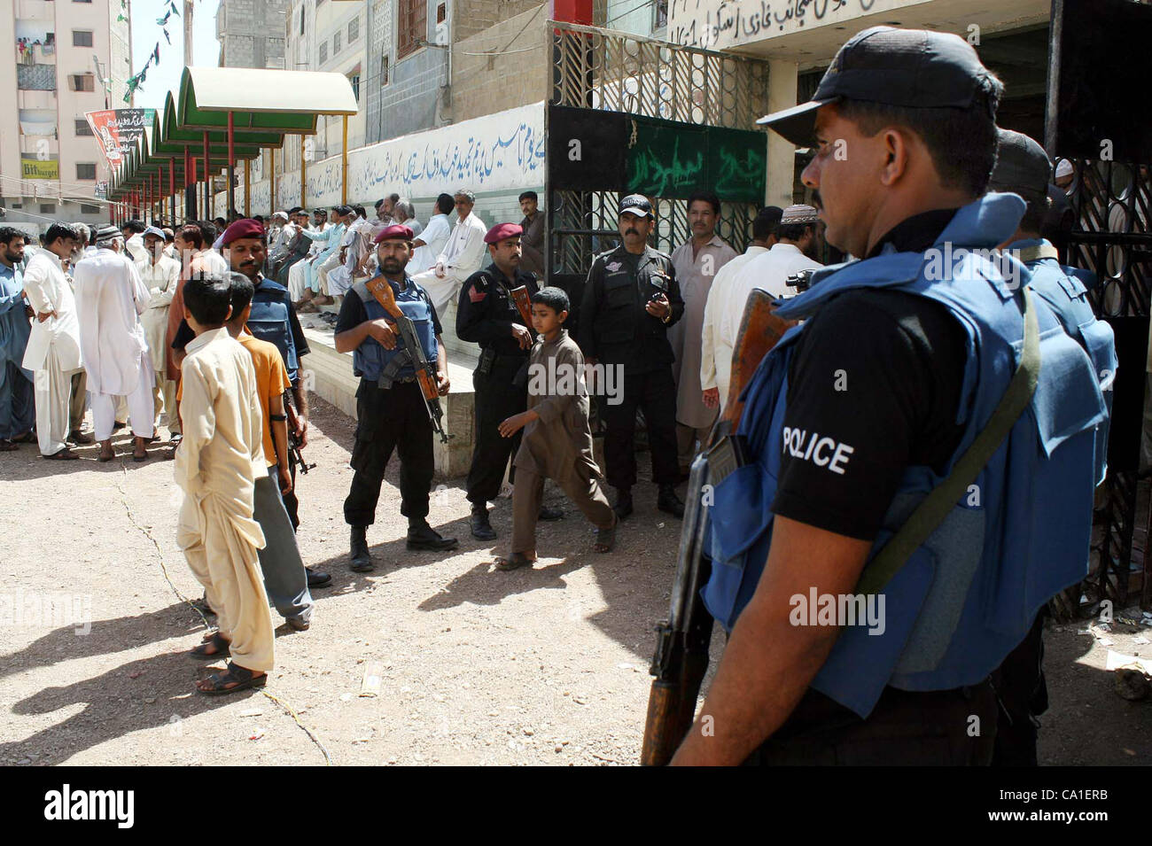 Policemen stand guard during funeral prayer of Abdul Rasheed and his ...