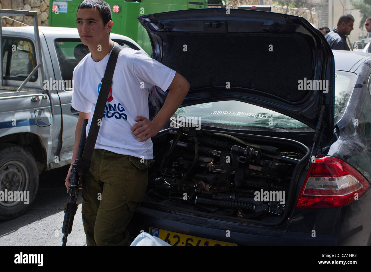 An IDF soldier of the Shachar Battalion keeps an eye on a trunk-full of ...