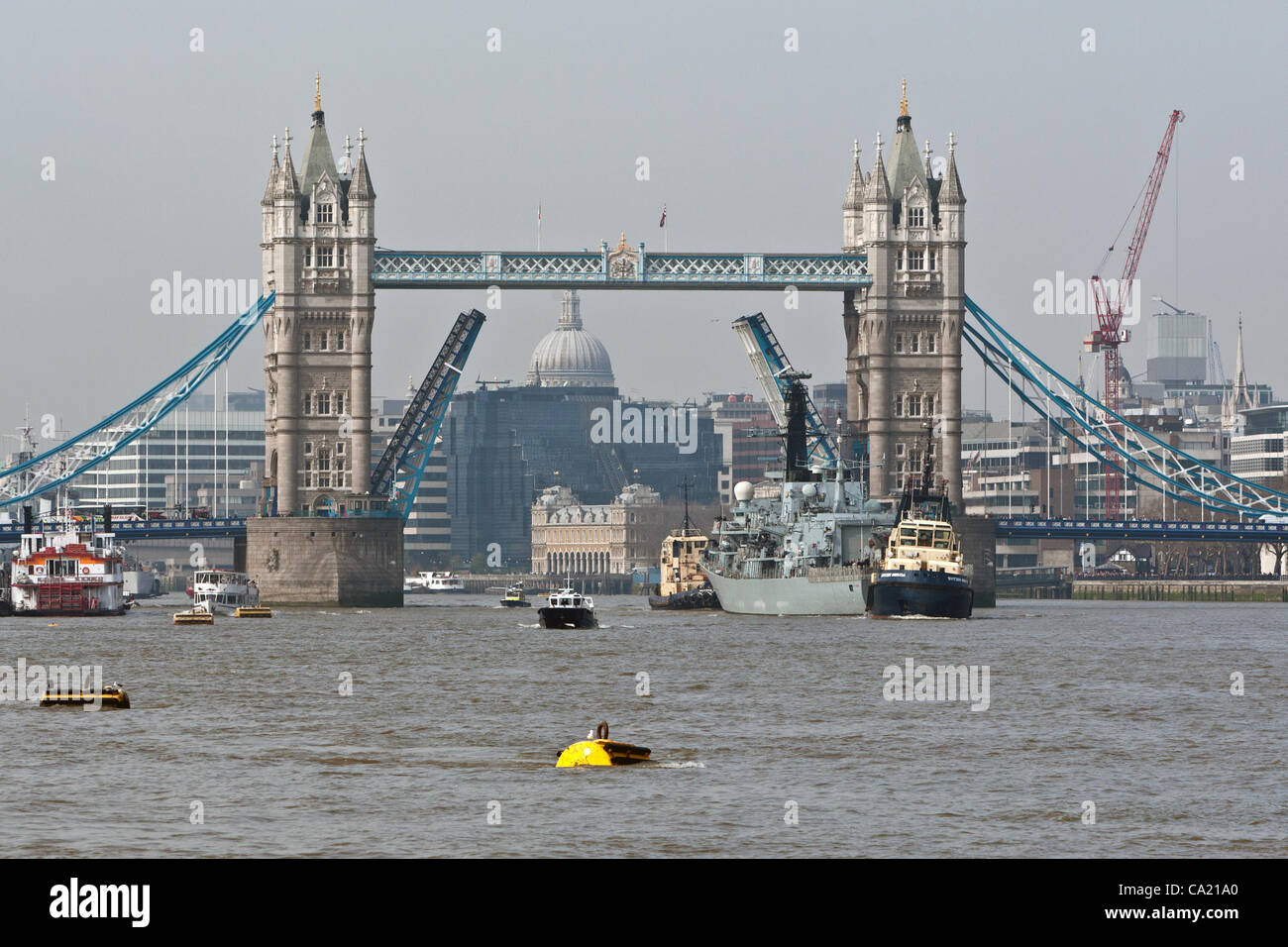 Bascules of Tower Bridge raised as tugs tow HMS St Albans as she leaves ...