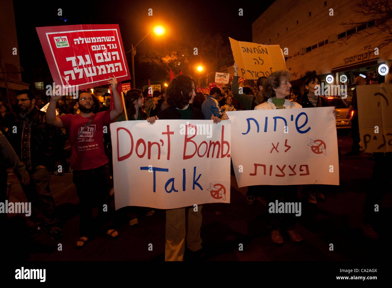 Israeli peace activists hold placards which reads "Dont bomb, talk" as ...