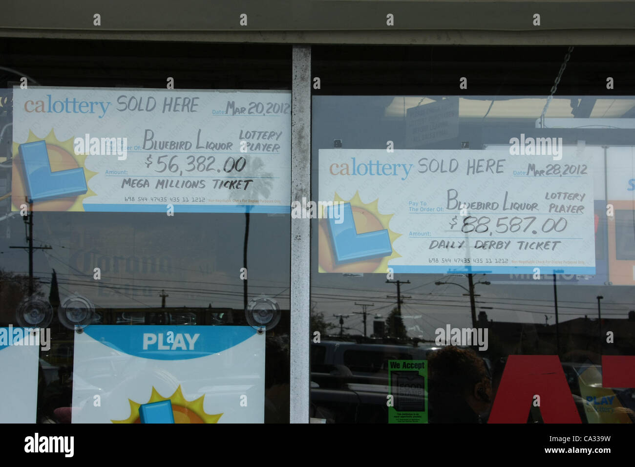 STORE WINDOW WITH PAST WINNERS CHEQUES MEGA MILLIONS. 540 MILLION ...