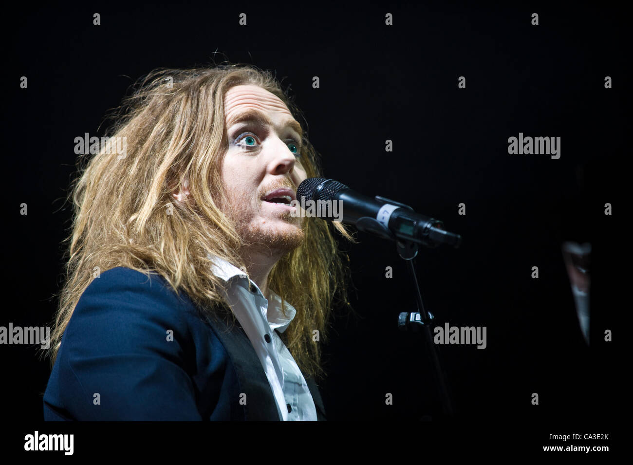 Tim Minchin, comedian and musician, performing on stage with his band ...